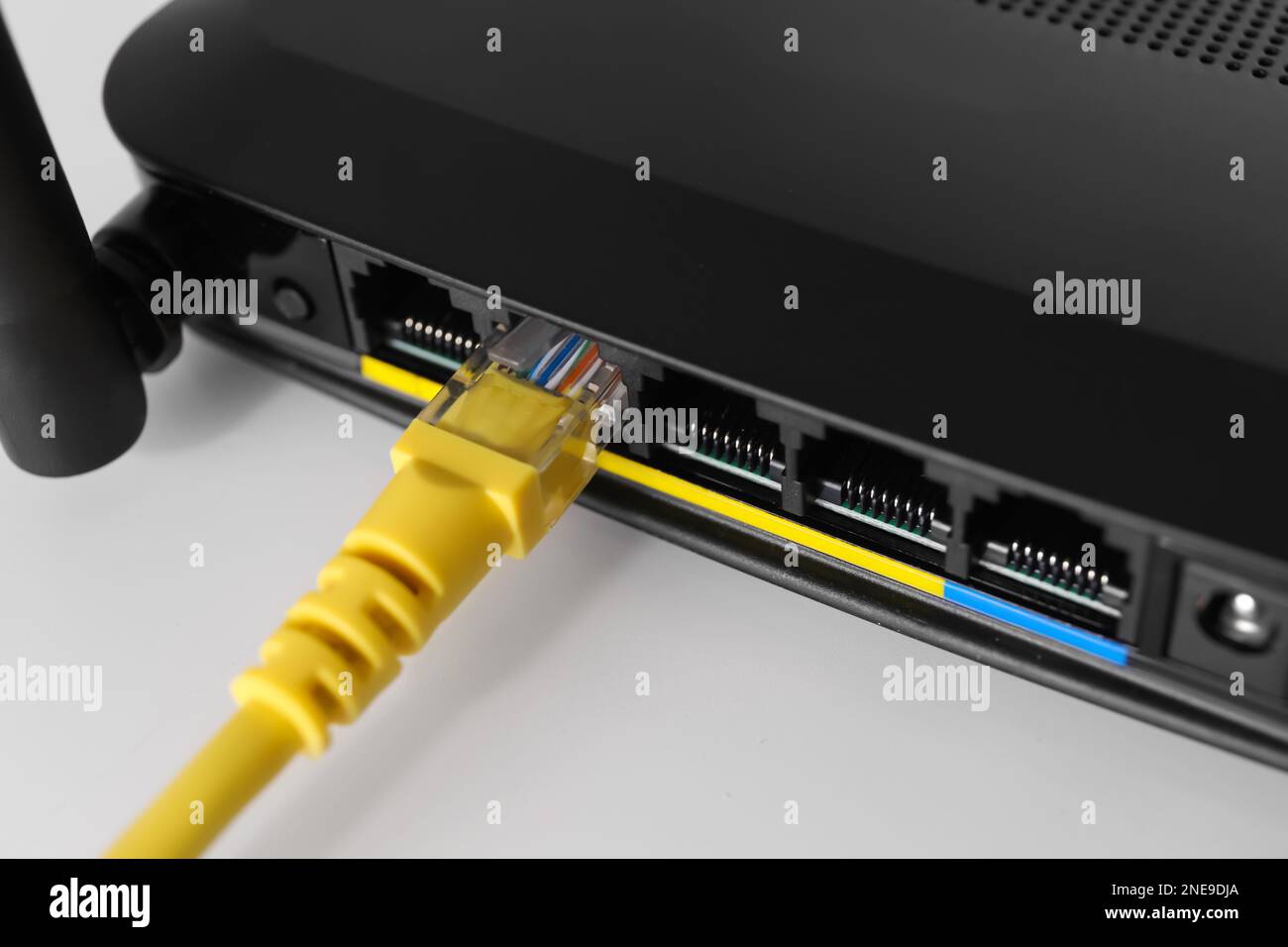 Connected cable to router on white table, closeup. Wireless internet ...
