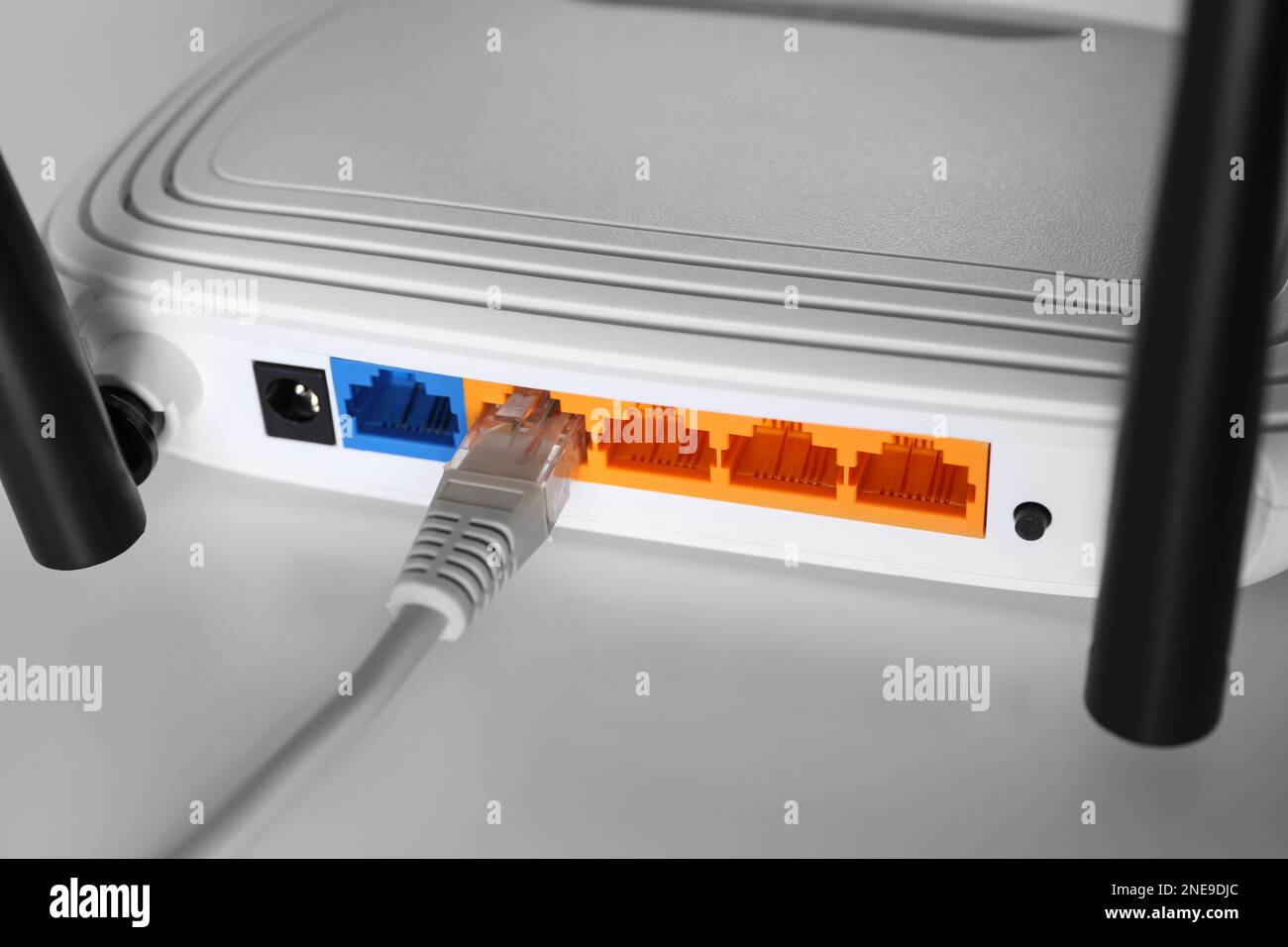 Connected cable to router on white table, closeup. Wireless internet ...
