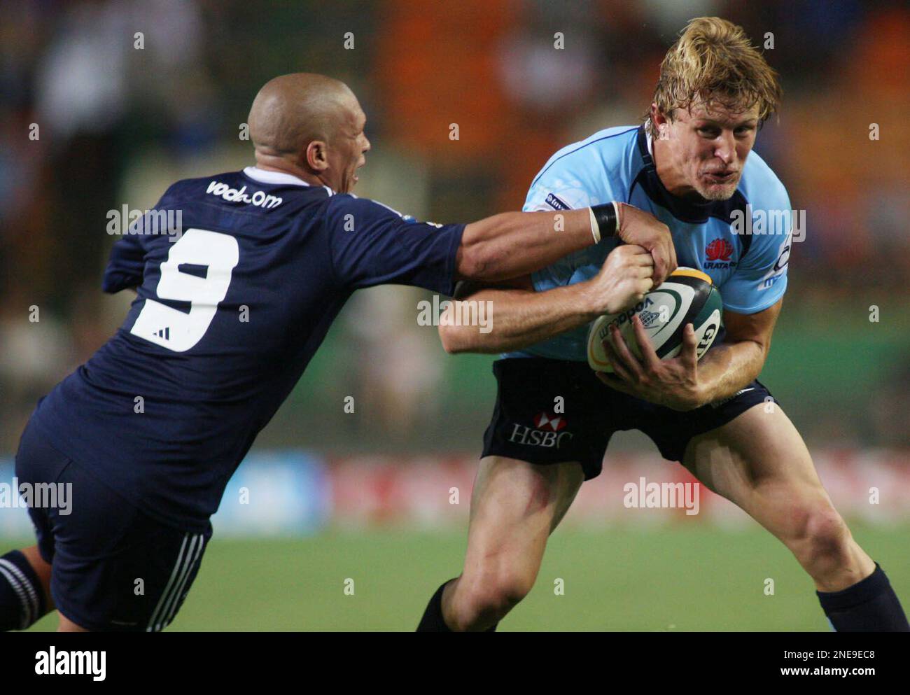 Lachie Turner of Australia's Waratahs, right, is tackled by Ricky ...