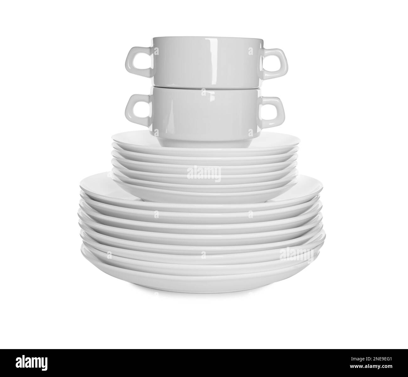 Stacked plates and cups on white background Stock Photo - Alamy