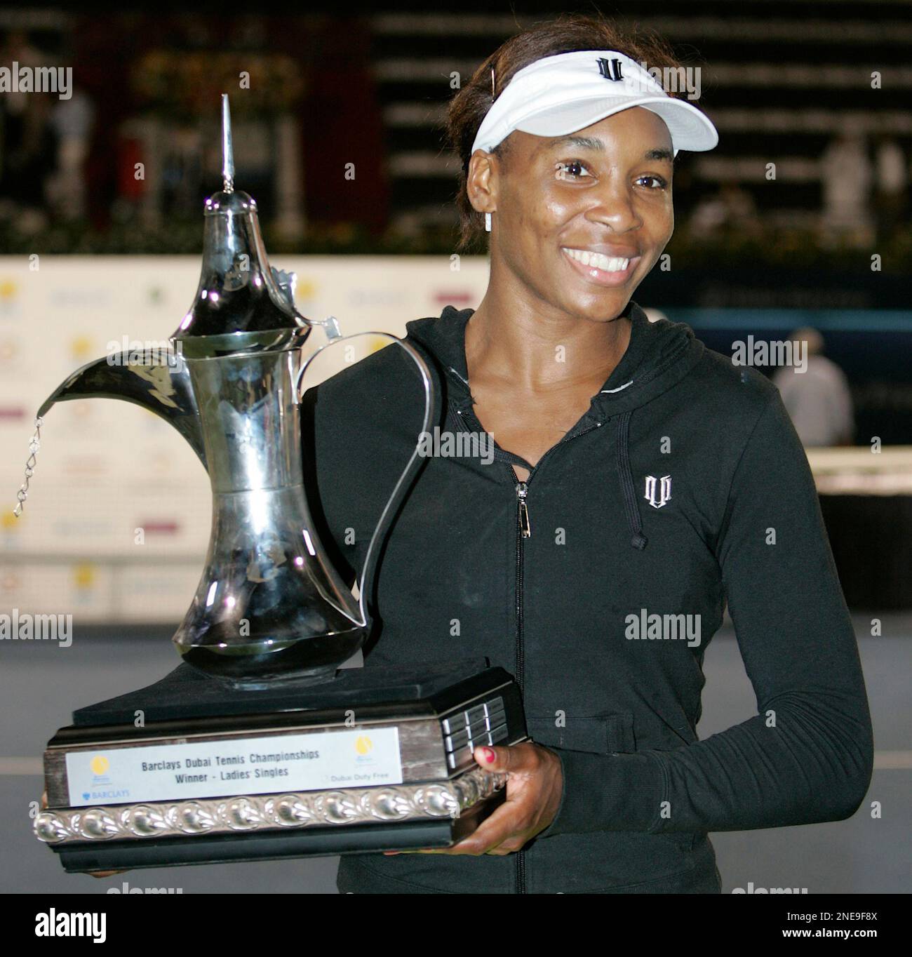 Venus Williams of the U.S. holds the trophy after she won her match ...