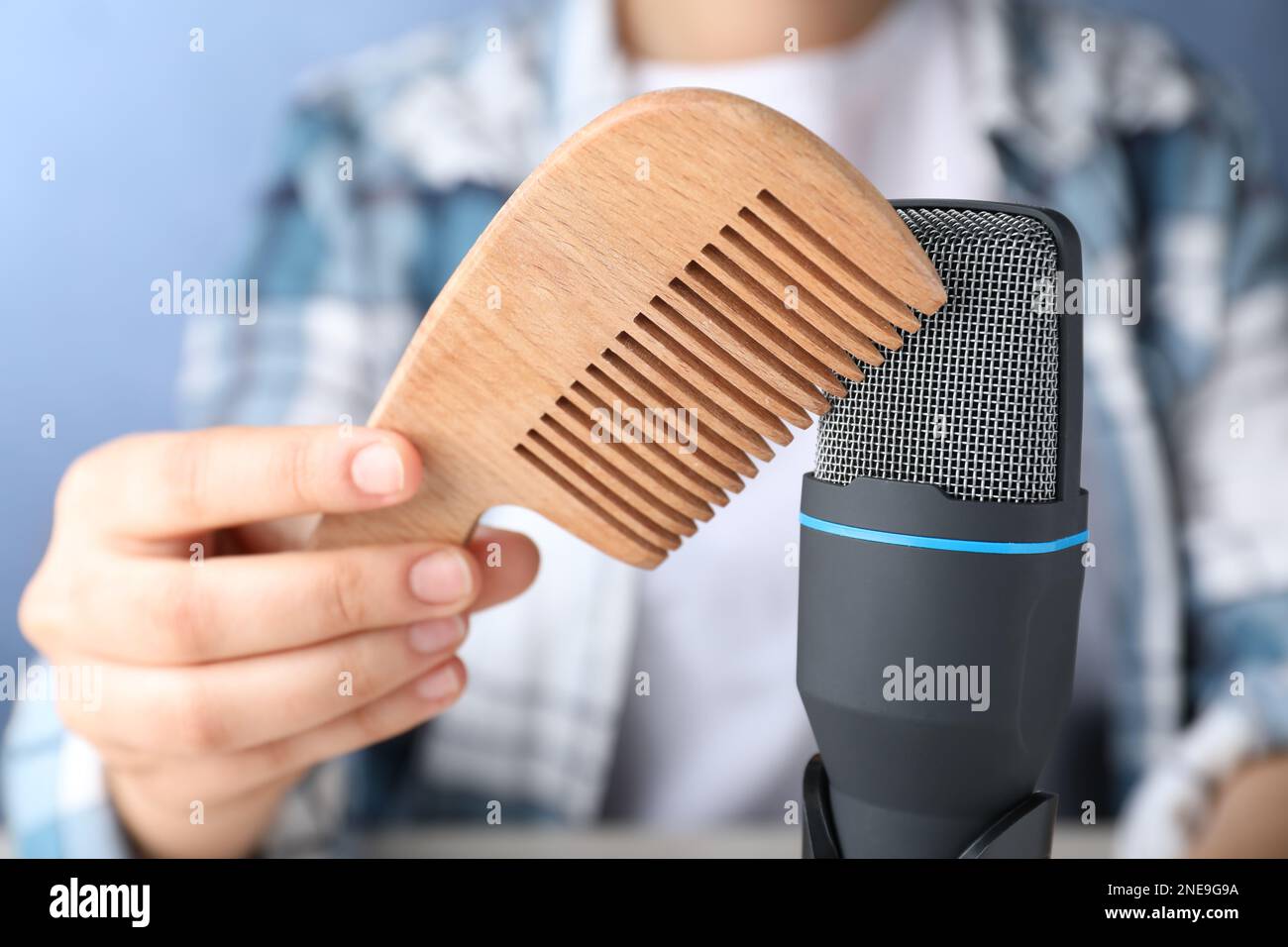 Woman making ASMR sounds with microphone and wooden comb, closeup Stock ...
