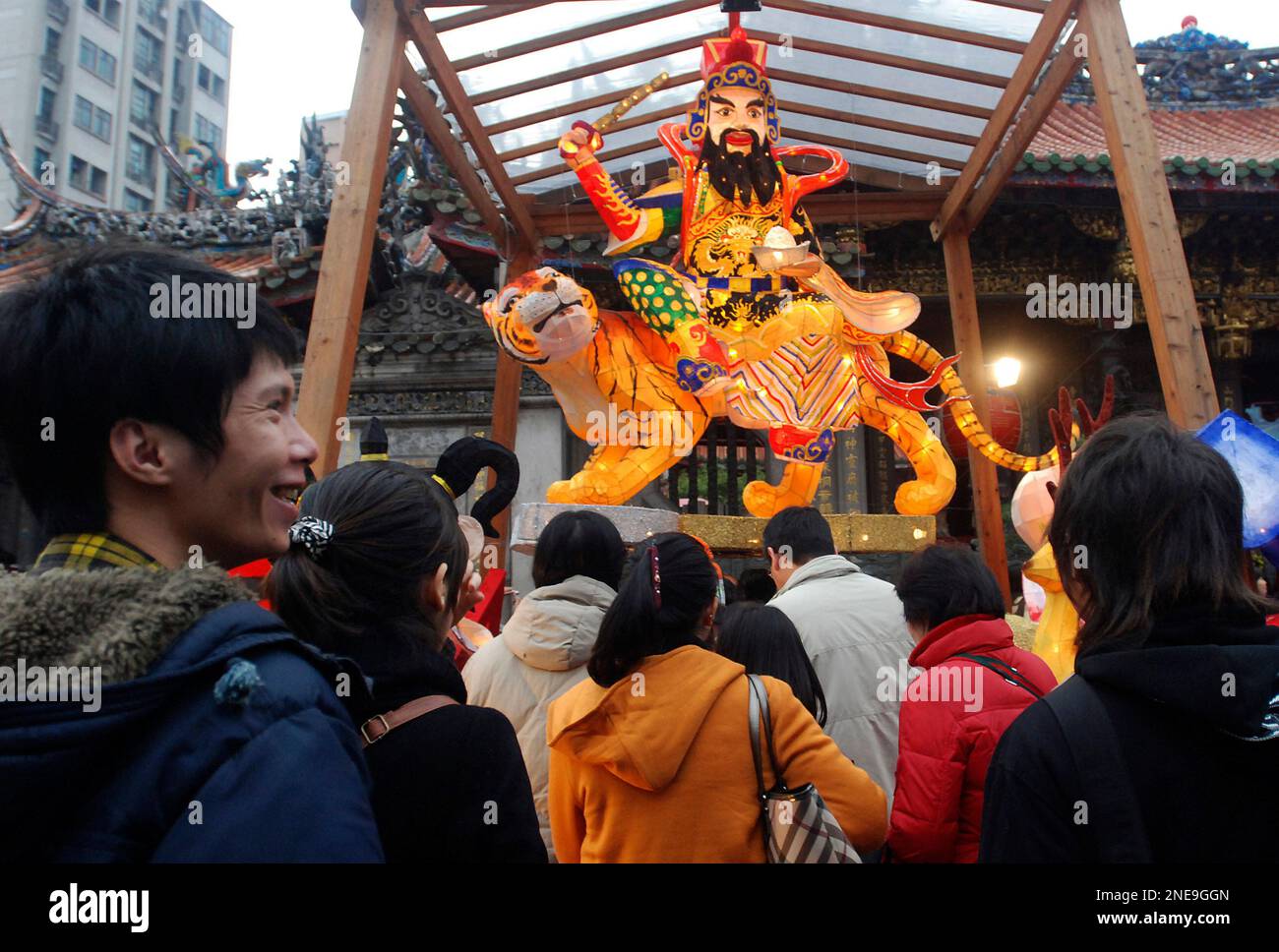 Taiwanese people line up to pray under the tiger lantern at the Long ...