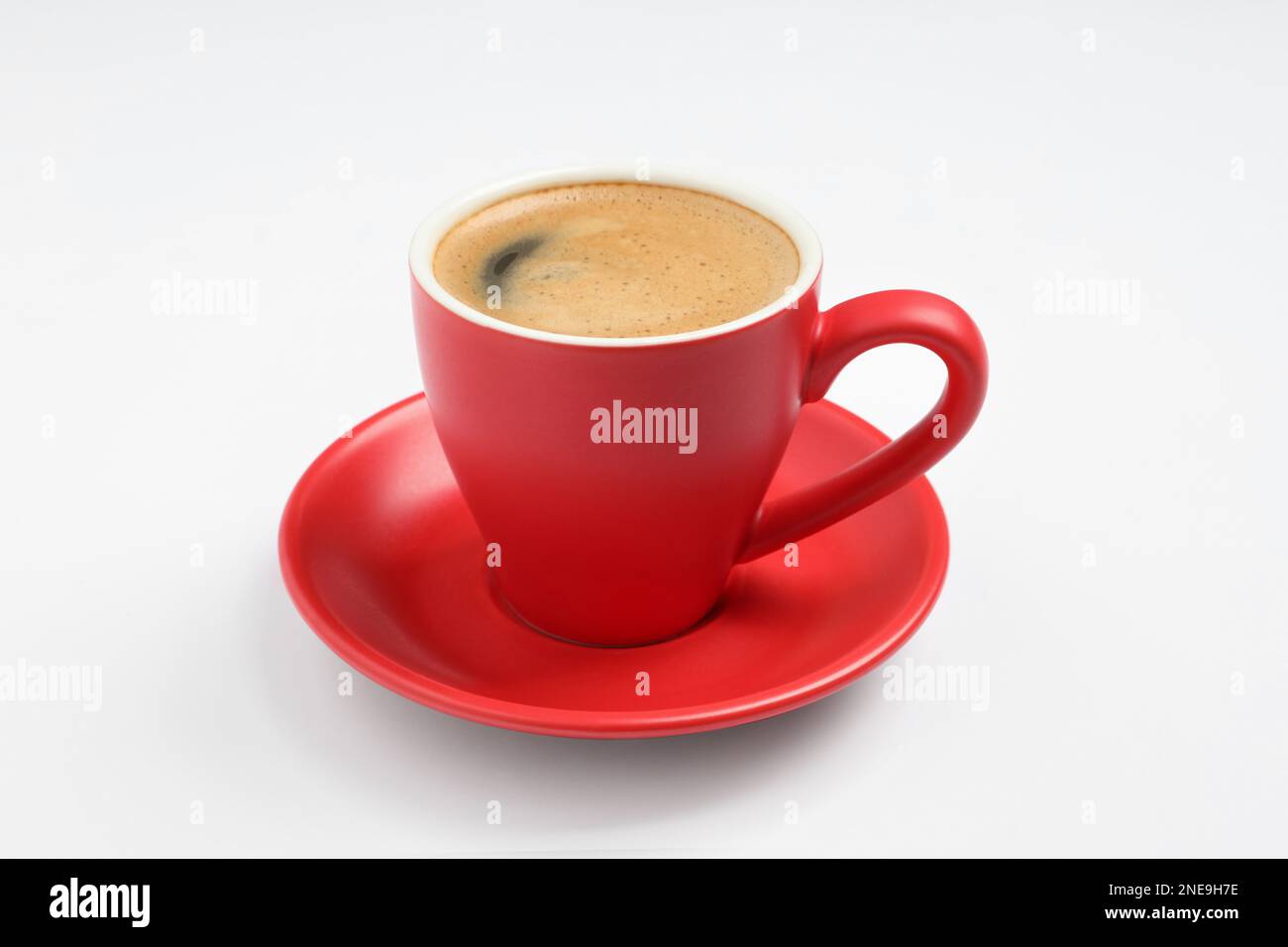 Aromatic coffee in red cup on white background Stock Photo - Alamy