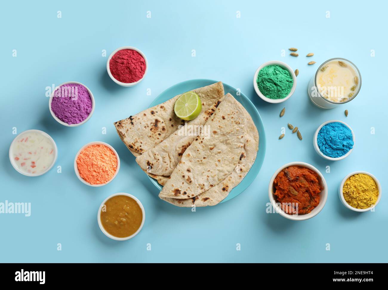 Traditional Indian food and color powder dyes on turquoise background ...