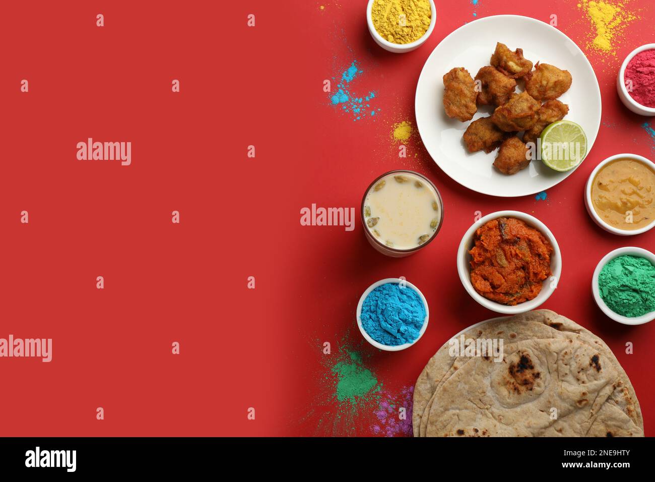 Flat lay of traditional Indian food and color powder dyes on red ...