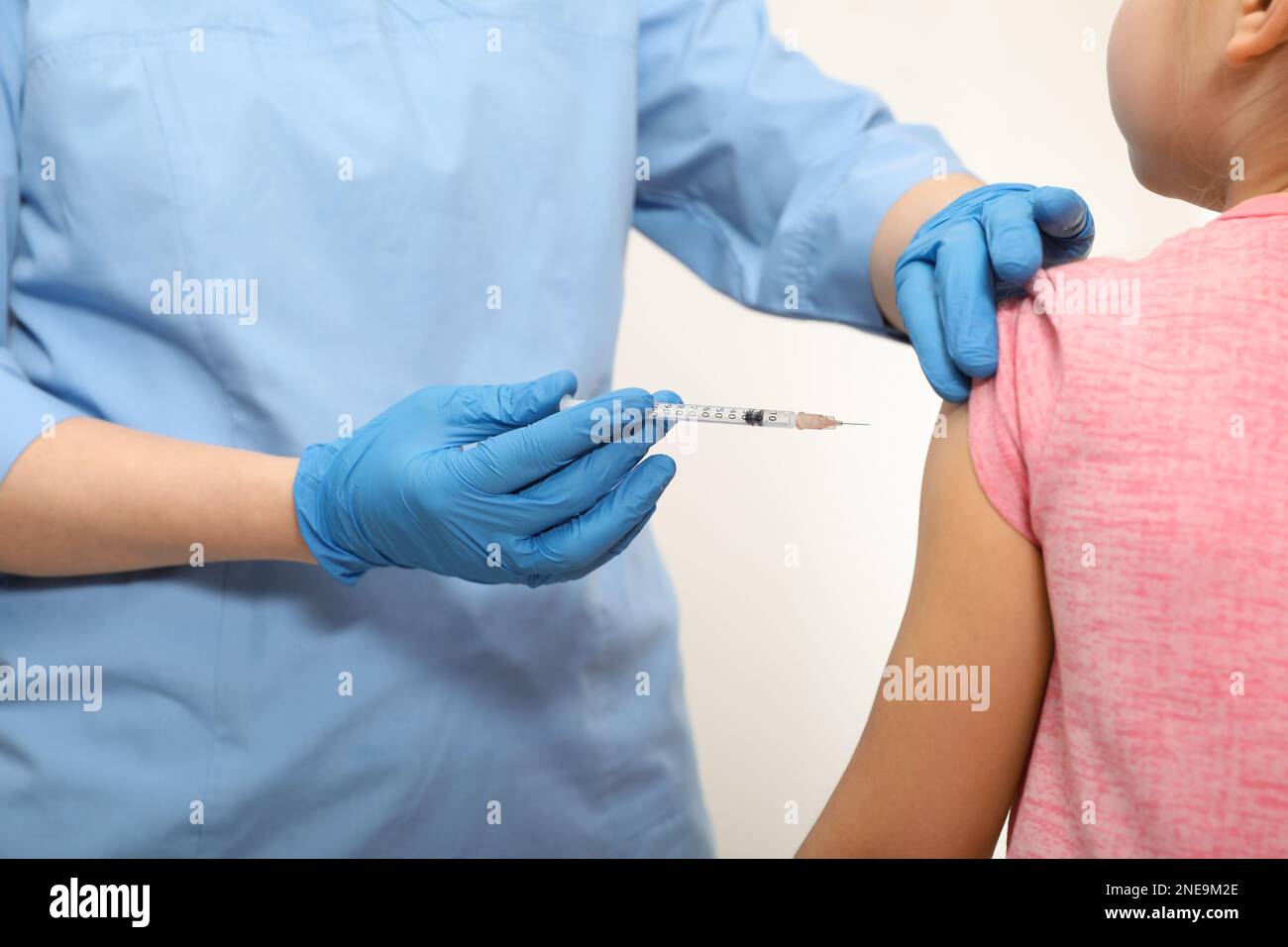 Doctor giving injection to little girl in hospital, closeup ...