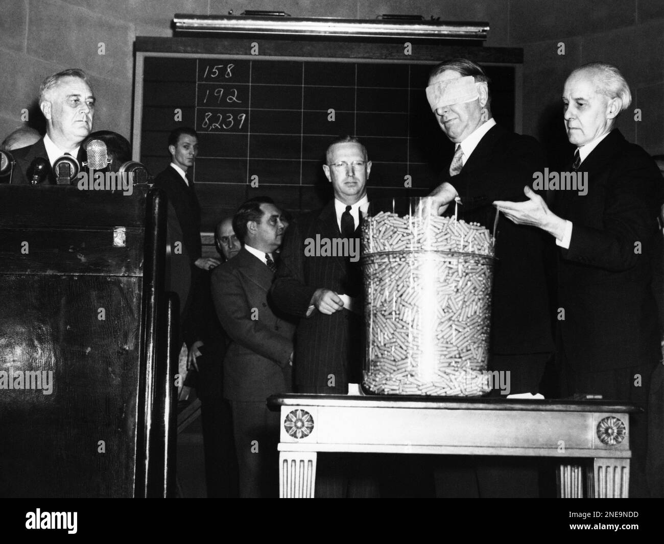 Secretary of navy Frank Knox (blindfolded) draws the fourth number?6620 ...