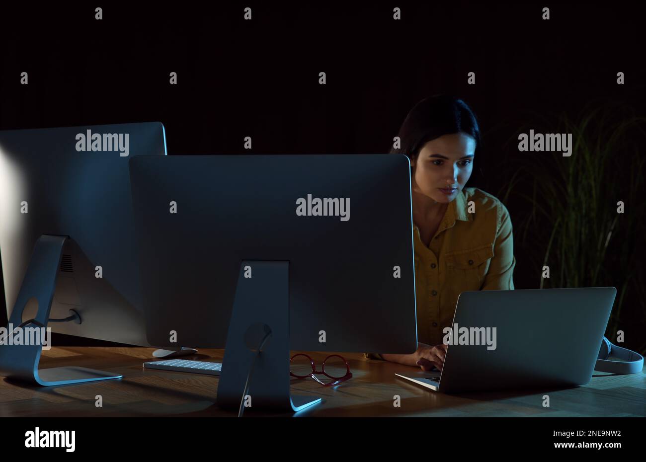 Programmer working in modern office at night Stock Photo - Alamy