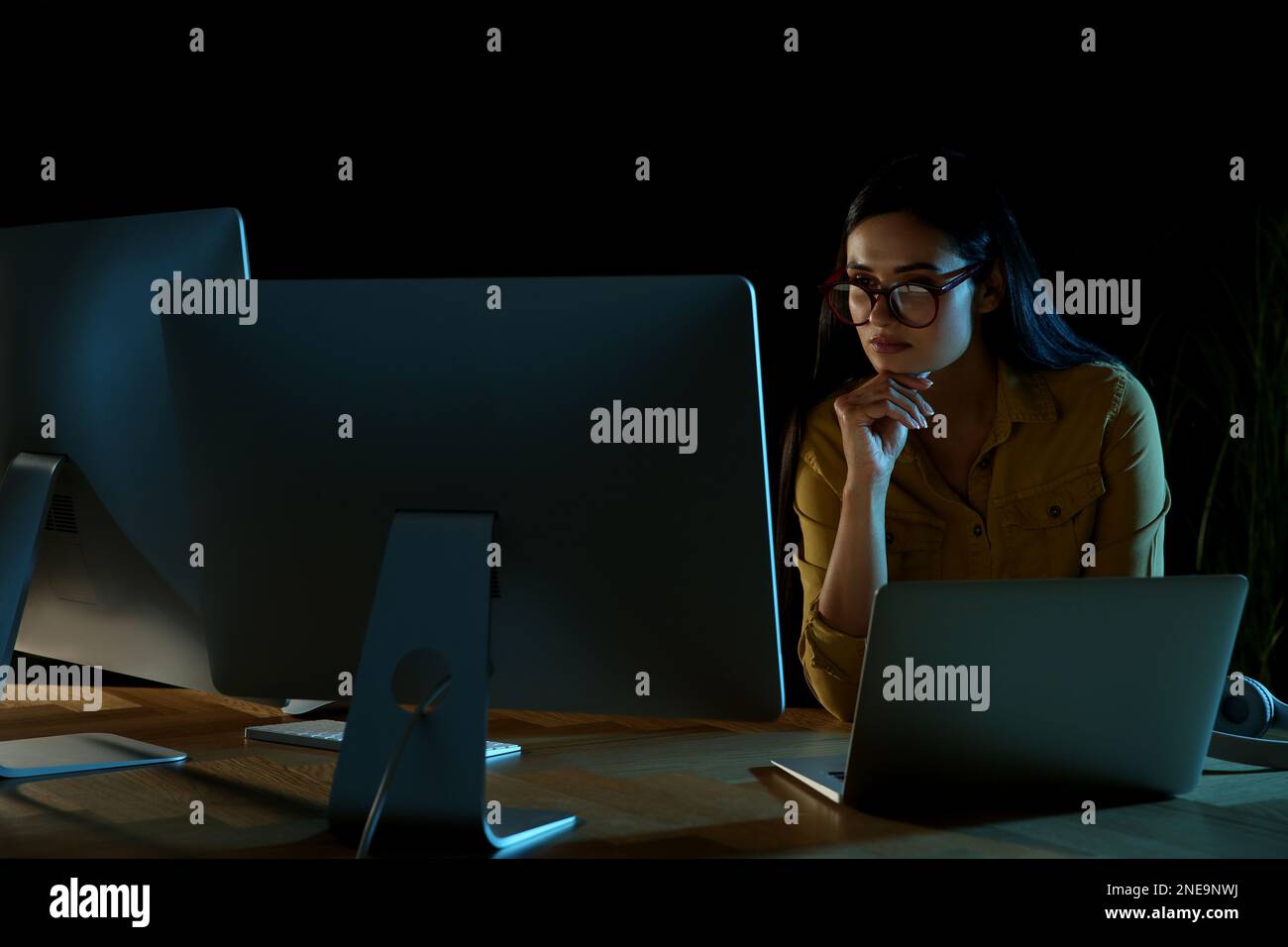 Programmer working in modern office at night Stock Photo - Alamy