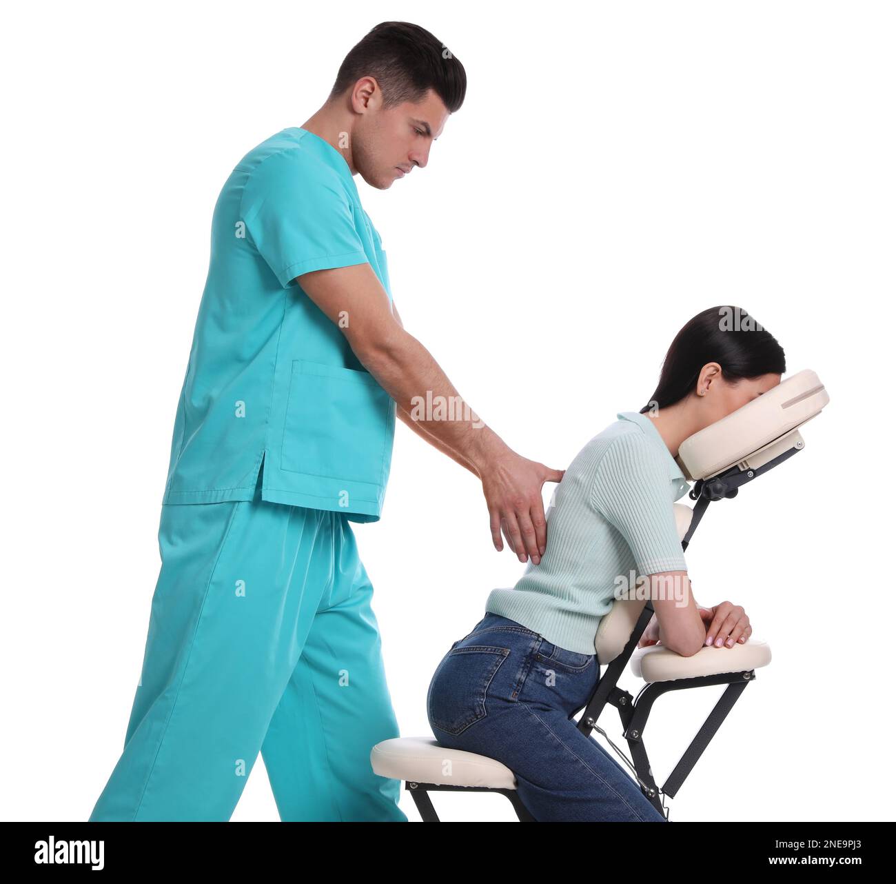 Woman receiving massage in modern chair on white background Stock Photo ...