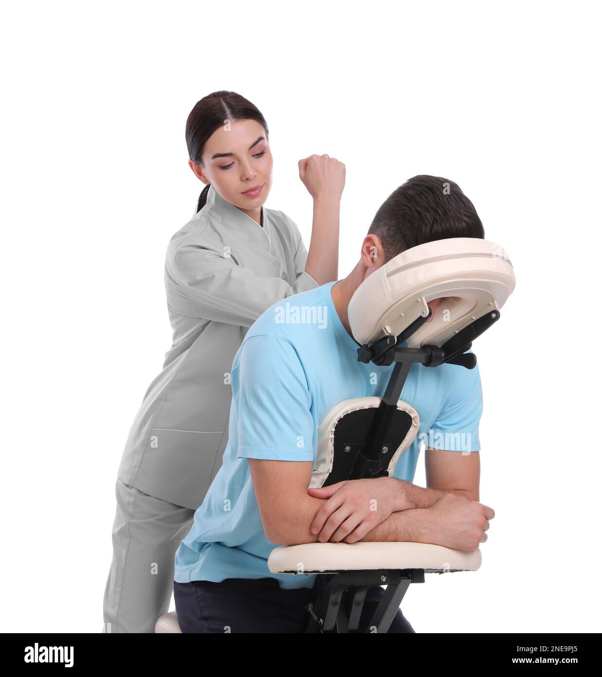 Man receiving massage in modern chair on white background Stock Photo ...
