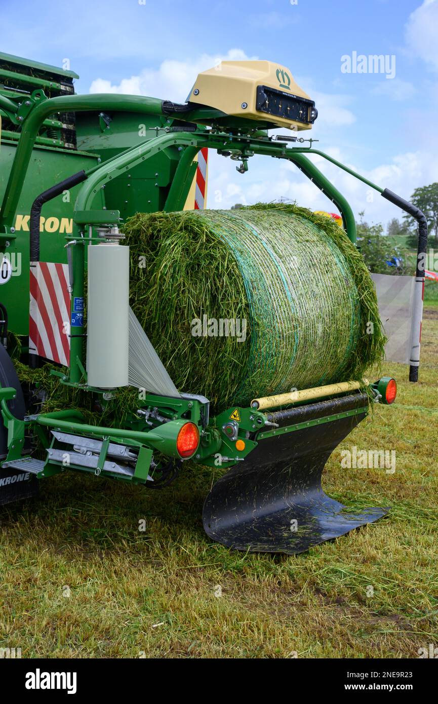 Krone baler making and wrapping a bale in one pass. Dumfries, Scotland ...
