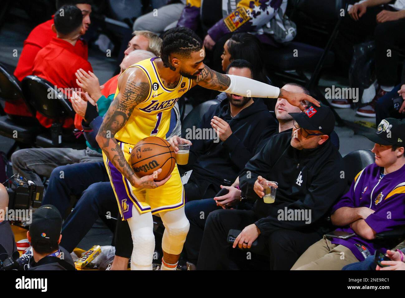 Los Angeles Lakers guard D'Angelo Russell comforts a fan after running ...