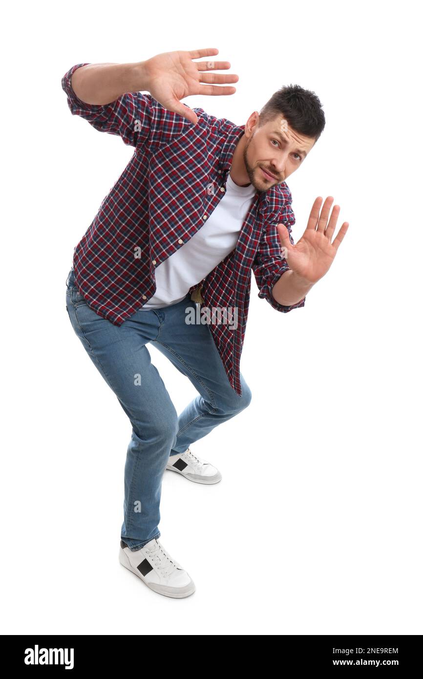Emotional man evading something on white background Stock Photo - Alamy