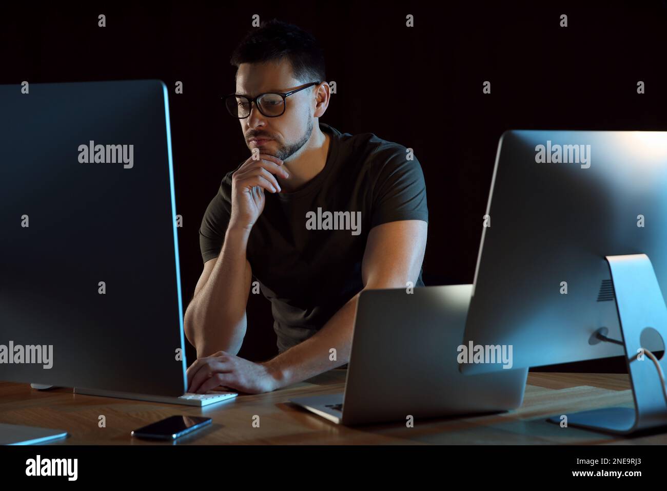 Programmer working in modern office at night Stock Photo - Alamy
