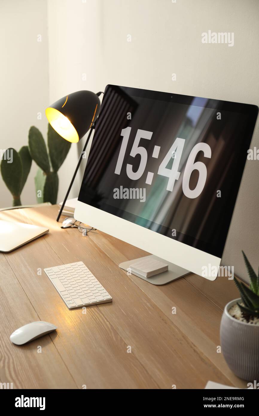 Modern computer and laptop on wooden desk in room. Interior design ...