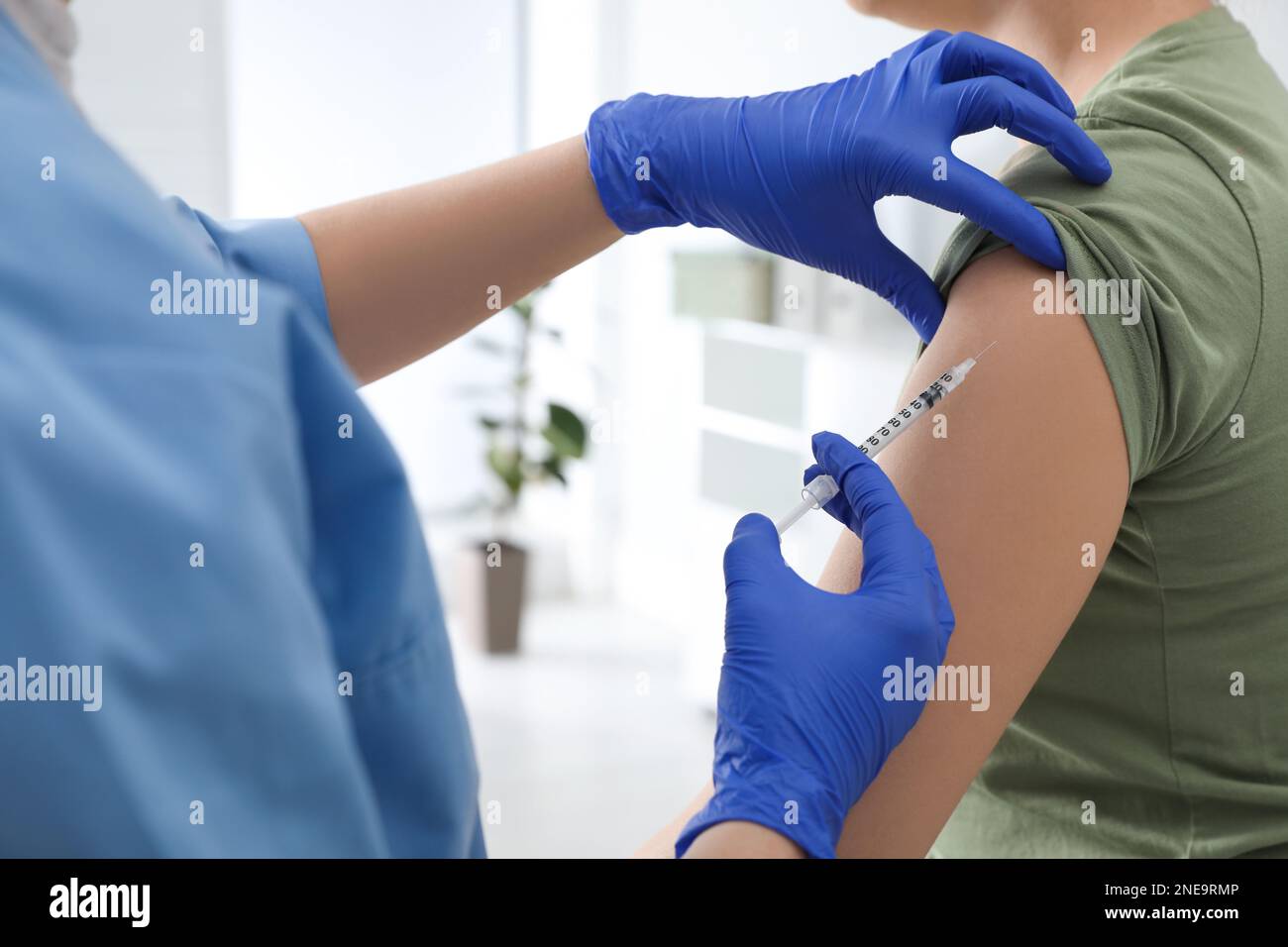Doctor giving injection to woman in hospital, closeup. Immunization ...