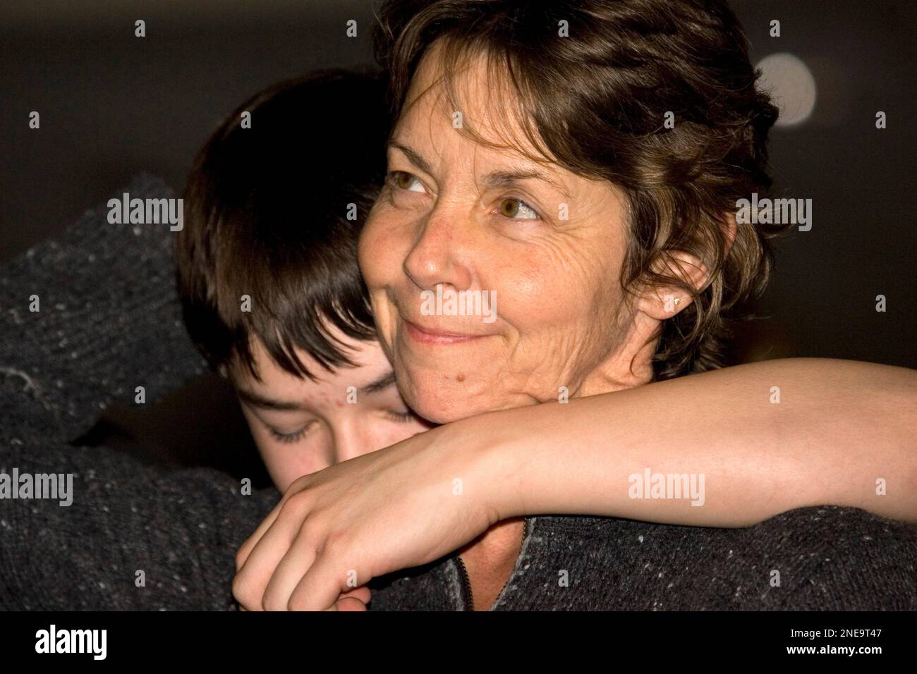 Carla Thompson, 53, right, of Meridian, Idaho, is hugged by her son ...