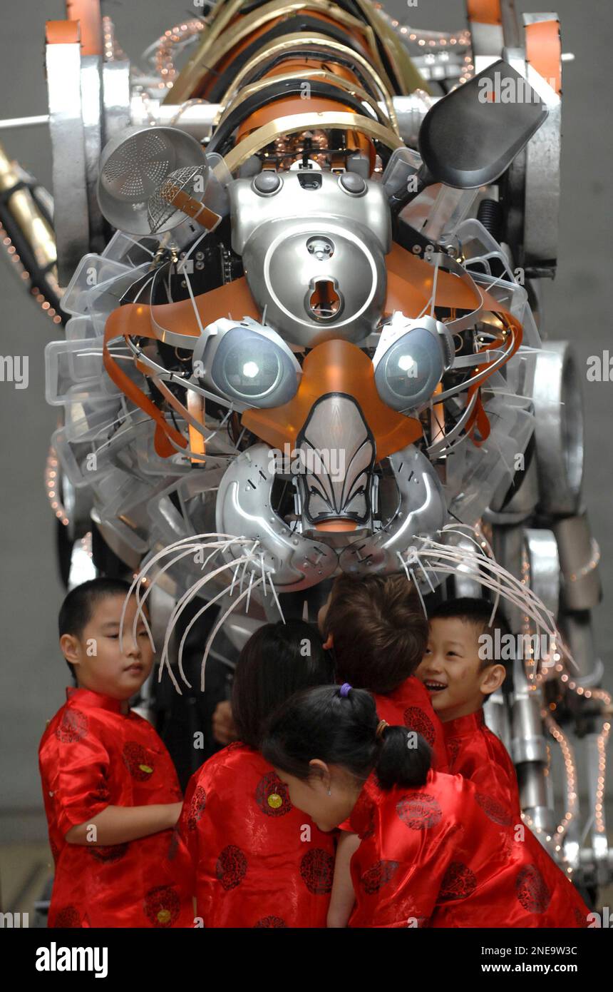 Children play with a giant metal tiger float in Sydney, Friday, Feb.19 ...