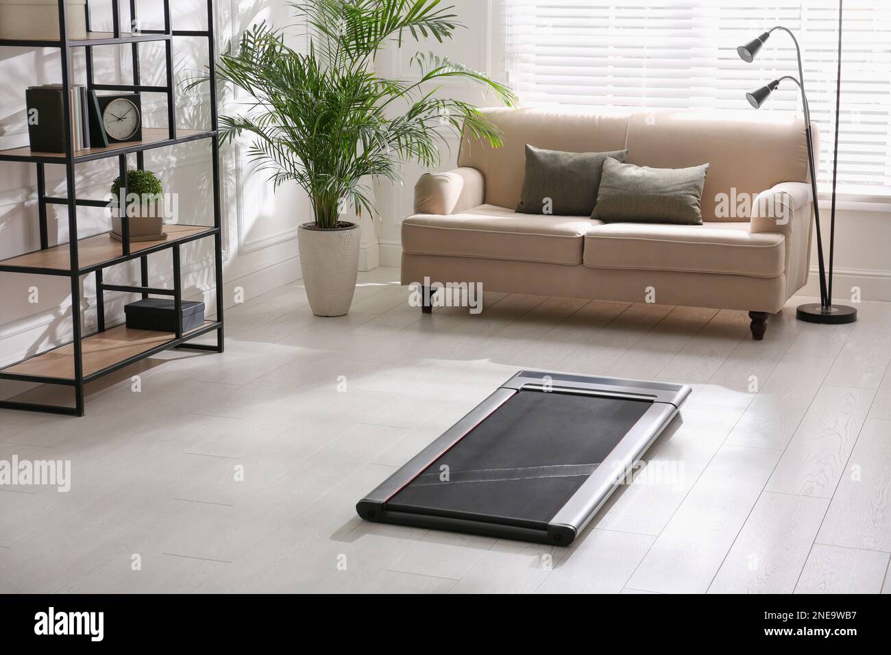 Modern walking treadmill in living room. Home gym equipment Stock Photo ...