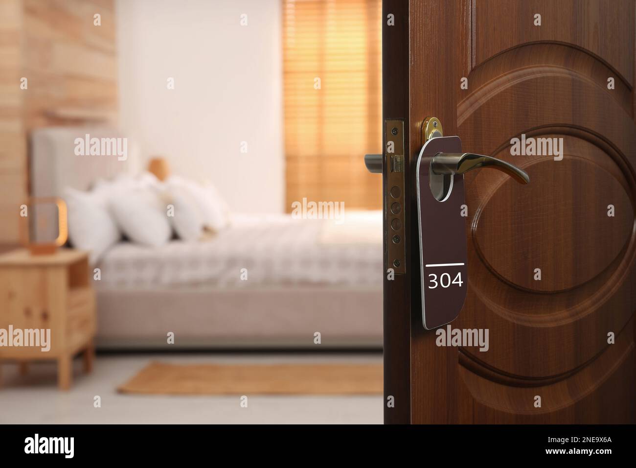 Wooden door open into modern hotel room, closeup Stock Photo - Alamy