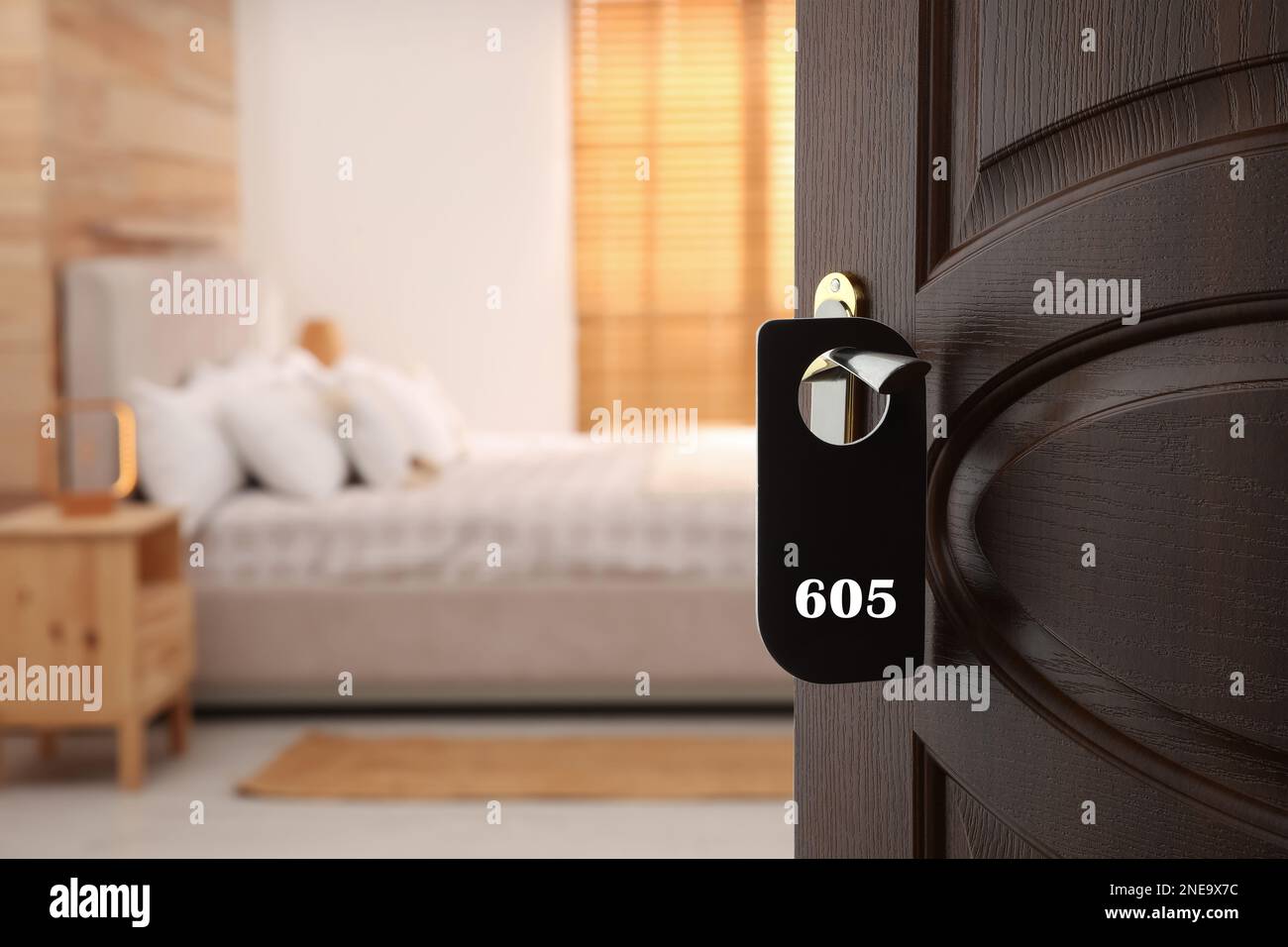 Wooden door open into modern hotel room, closeup Stock Photo - Alamy