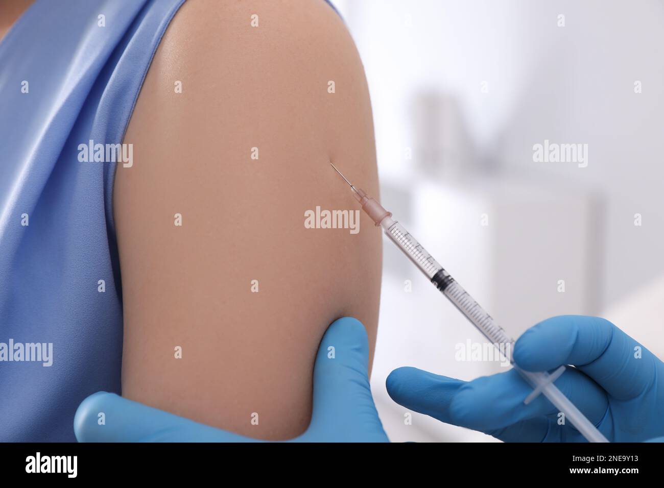 Doctor giving injection to woman in hospital, closeup. Immunization ...