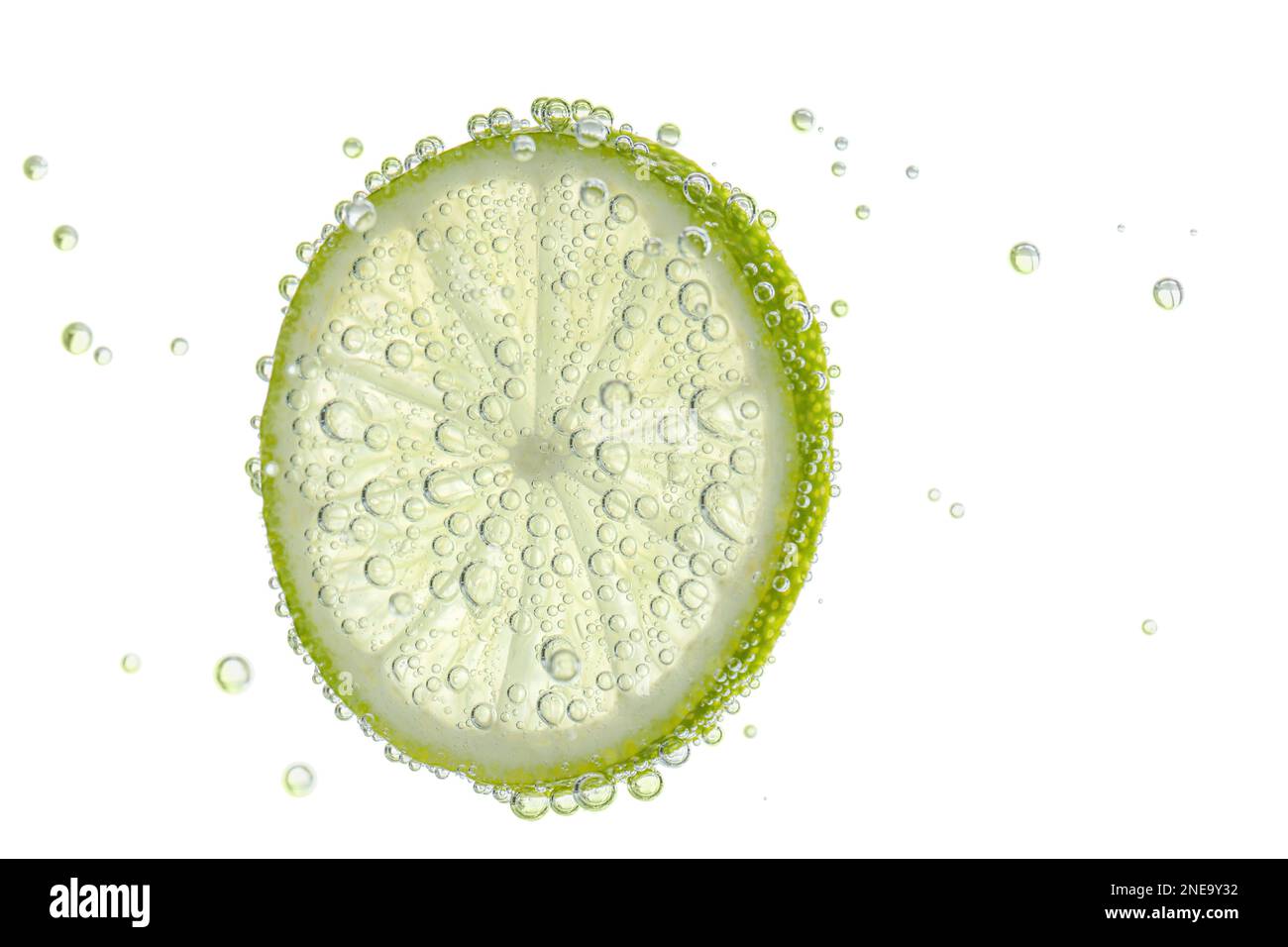 Fresh lime slice in sparkling water on white background Stock Photo - Alamy