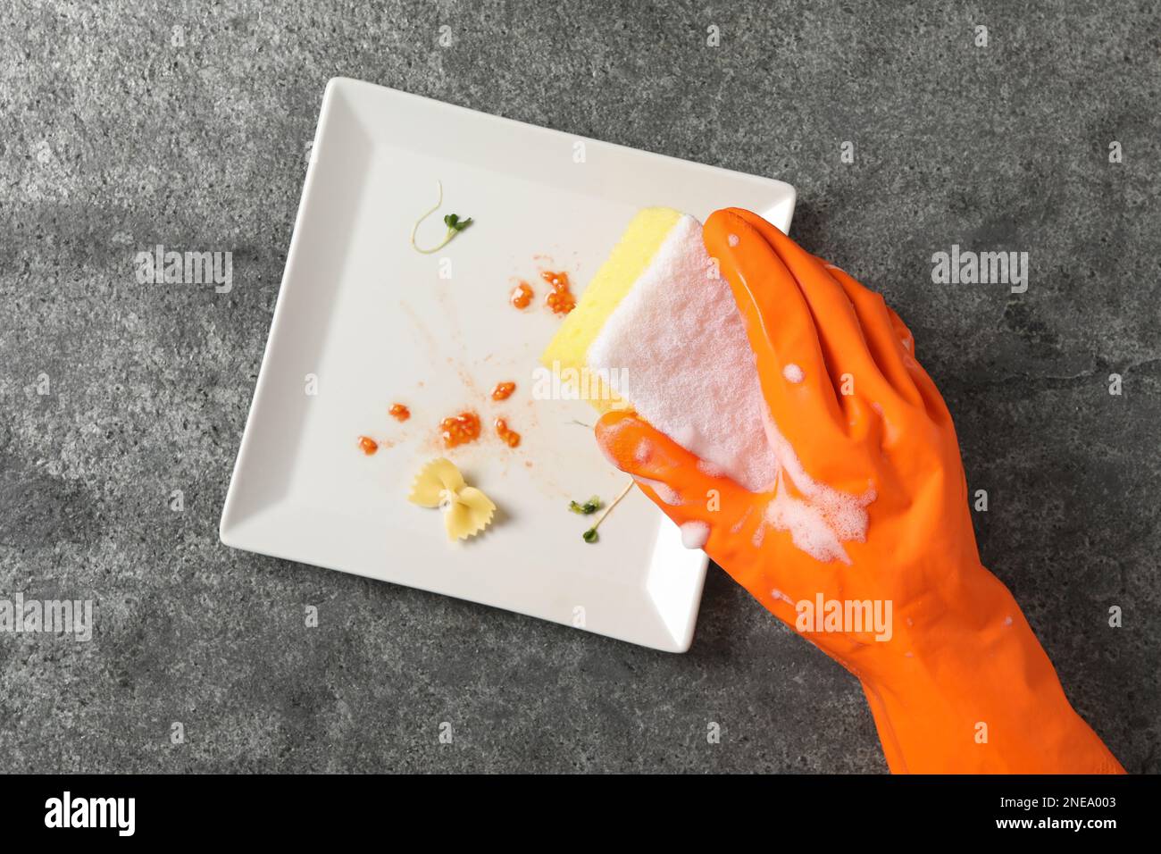 Woman washing dirty plate hi-res stock photography and images - Alamy