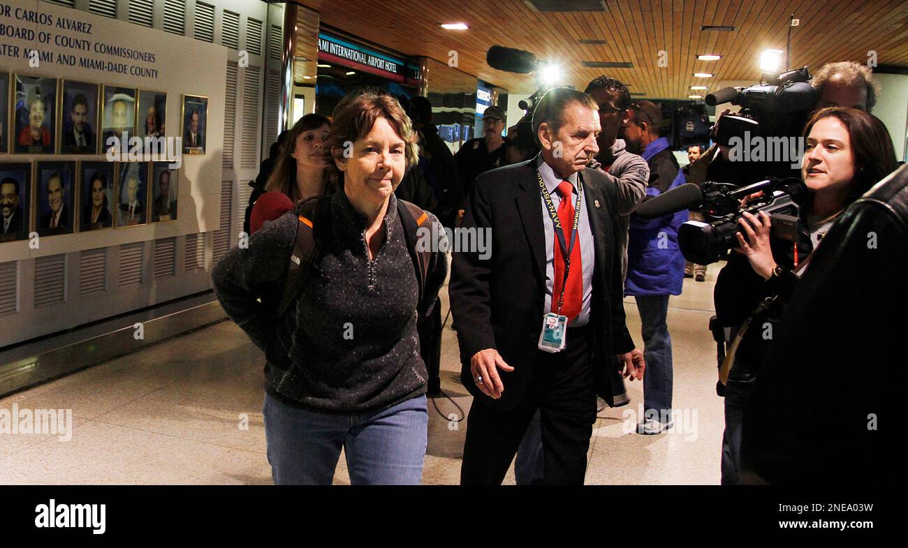 Carla Thompson, of Meridian, Idaho, is escorted to a waiting elevator ...