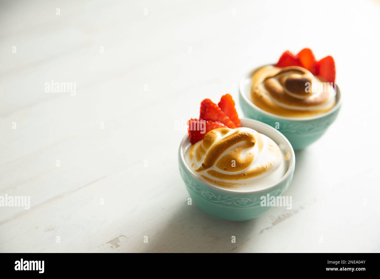 Baked meringue with strawberries and egg Stock Photo - Alamy