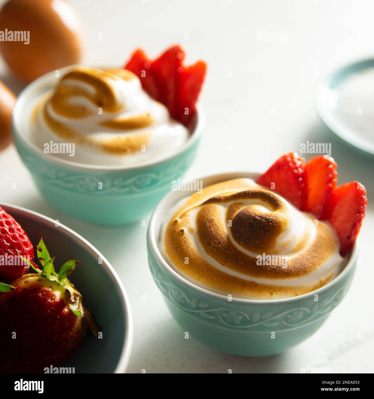 Baked meringue with strawberries and egg Stock Photo - Alamy