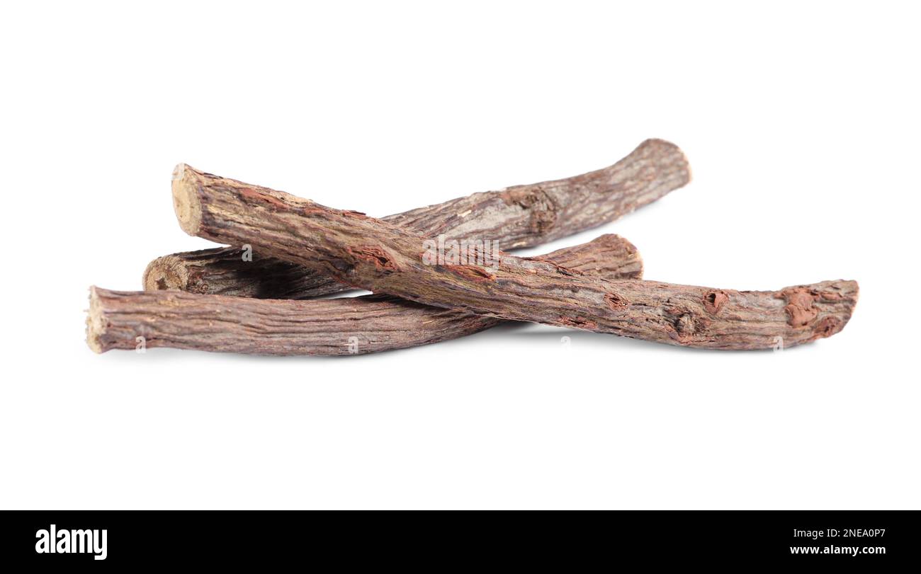 Dried sticks of liquorice root on white background Stock Photo - Alamy