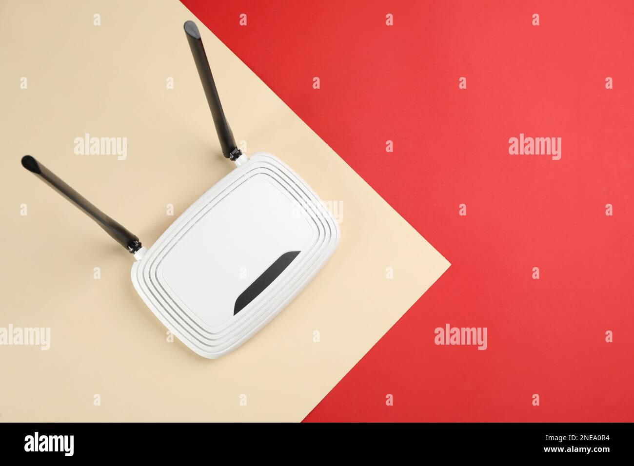 Modern Wi-Fi router on color background, top view. Space for text Stock ...
