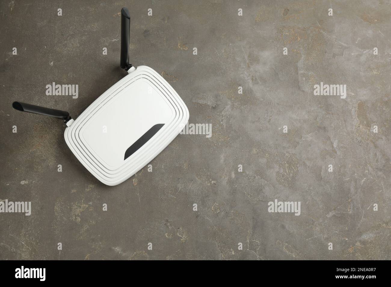 Modern Wi-Fi router on grey background, top view. Space for text Stock ...