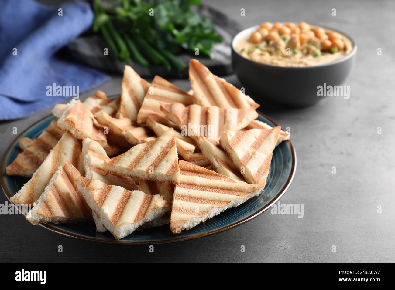Delicious crispy pita chips on grey table Stock Photo - Alamy