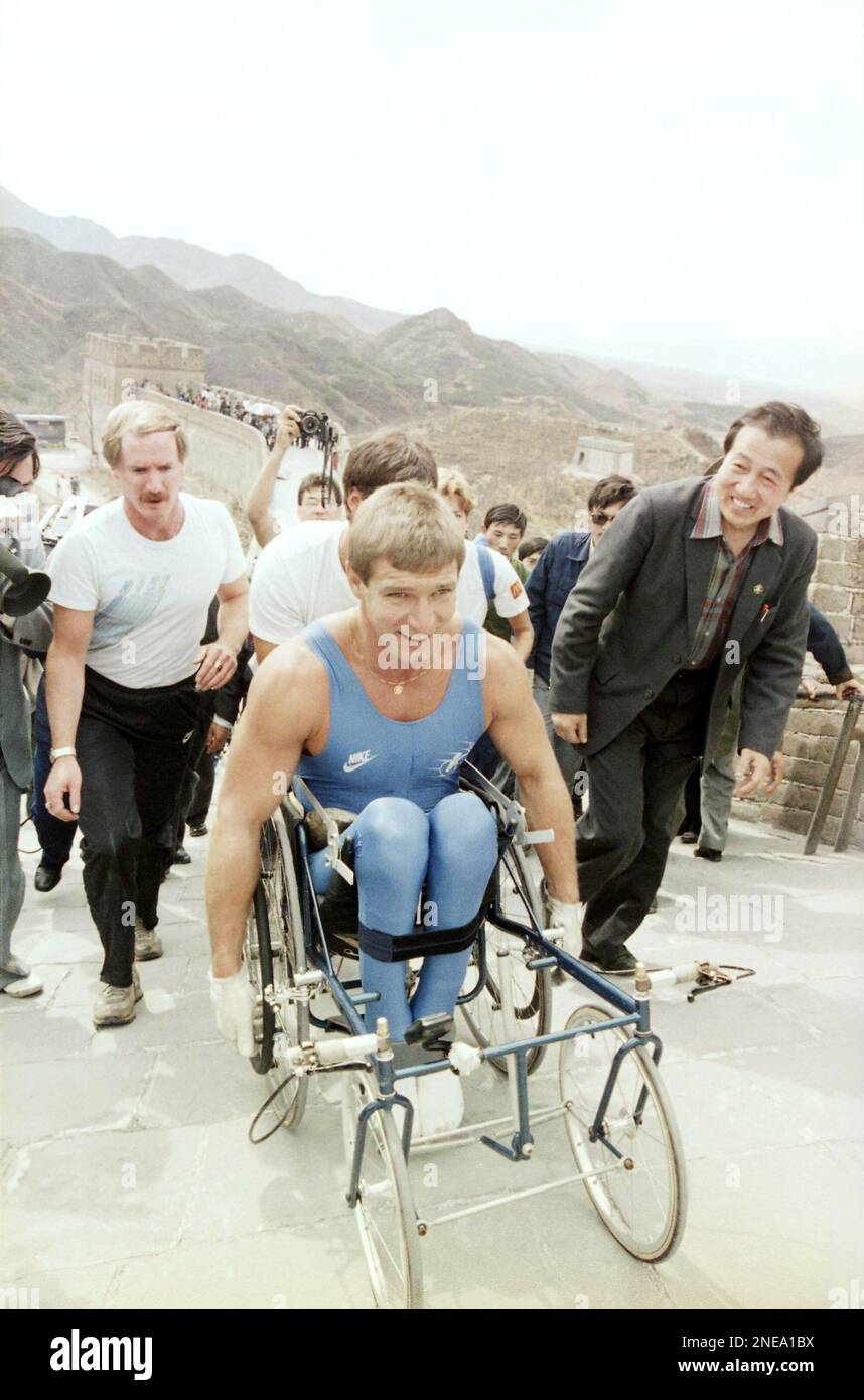 Canadian wheelchair athlete Rick Hansen propels himself up a steep ...