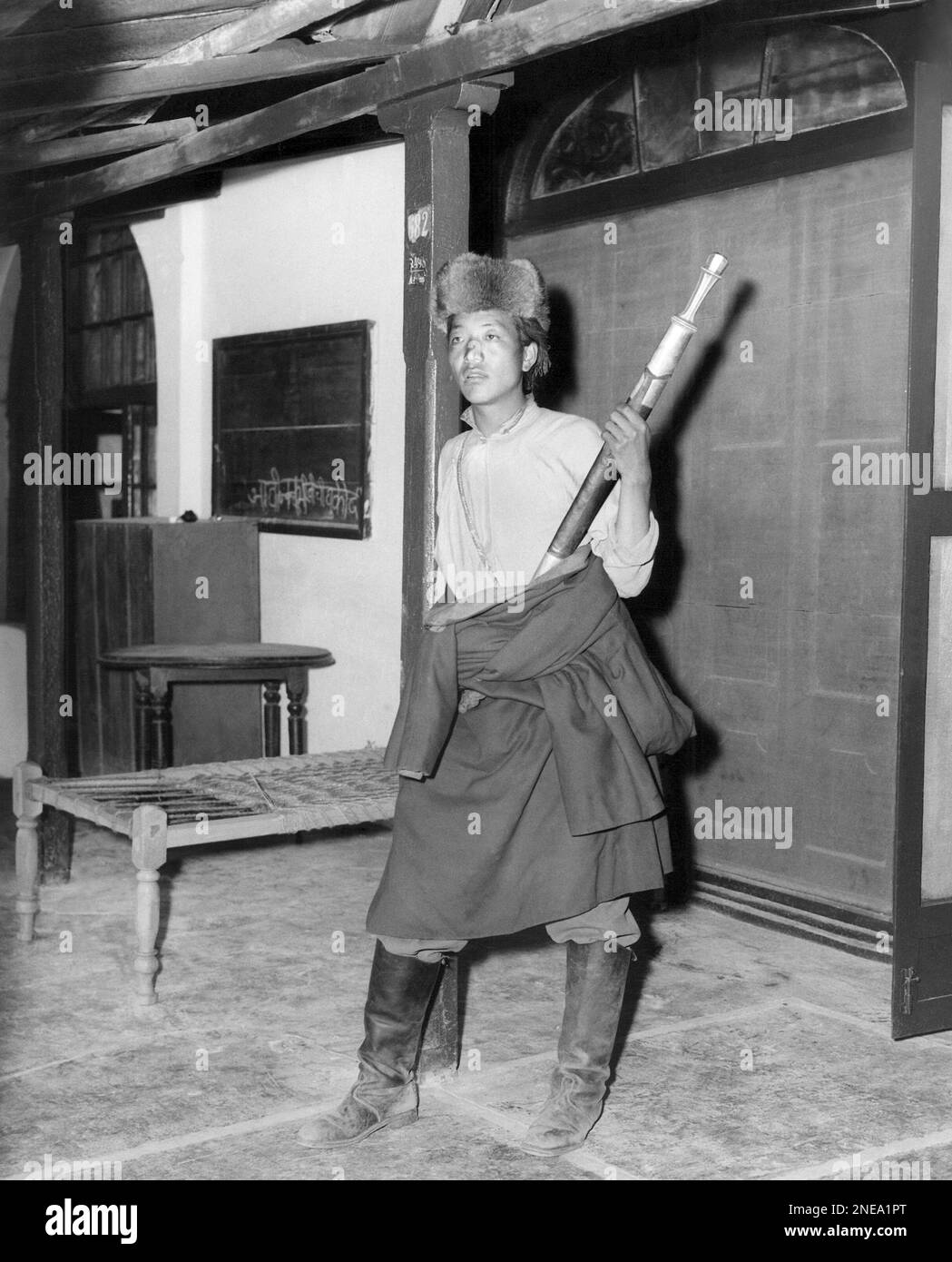 Armed with a huge sword, a member of the Dalai Lama's Tibetan bodyguard ...