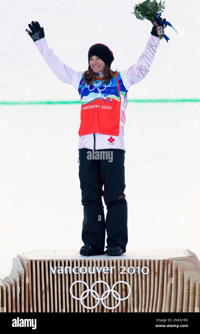 Maelle Ricker holds up the her flowers as she stands on the winner's ...