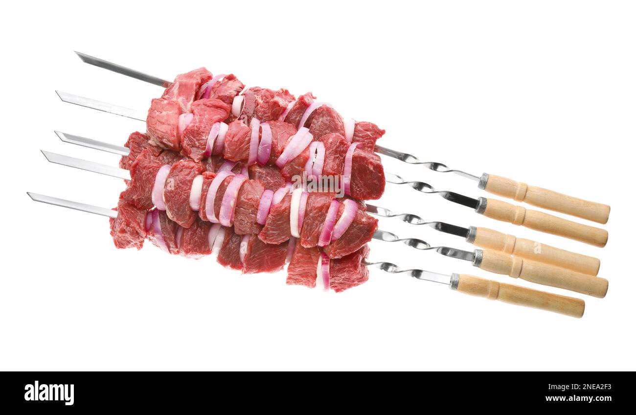 Metal skewers with raw meat and onion on white background Stock Photo ...