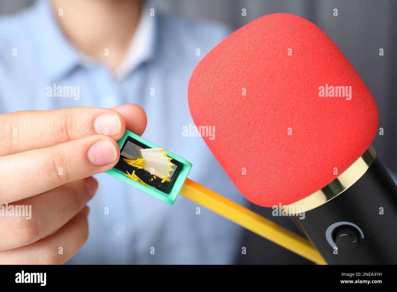 Woman making ASMR sounds with microphone, pencil and sharpener, closeup ...