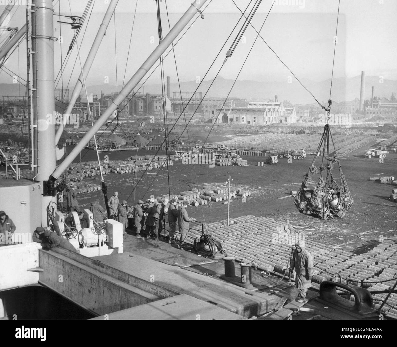 Petroleum supplies are swung aboard a transport during the evacuation ...