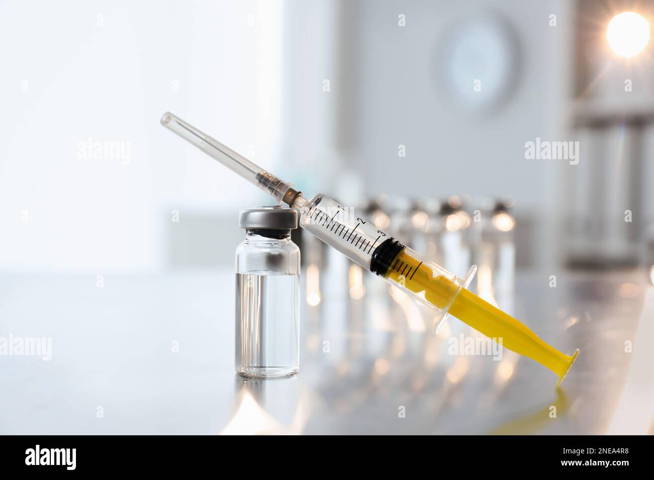 Syringe with vial of medicine on table Stock Photo - Alamy