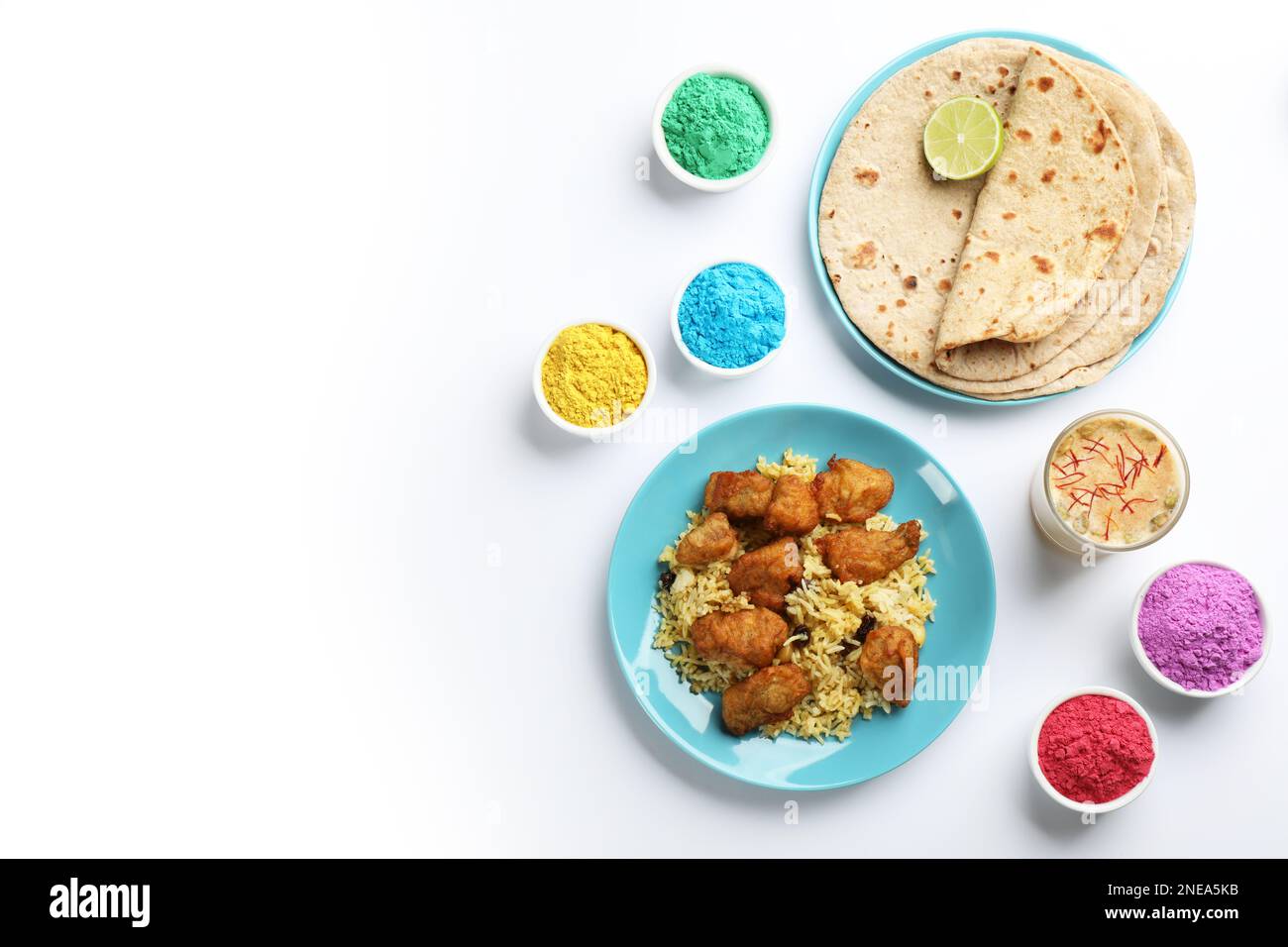 Flat lay of traditional Indian food and color powder dyes on light ...