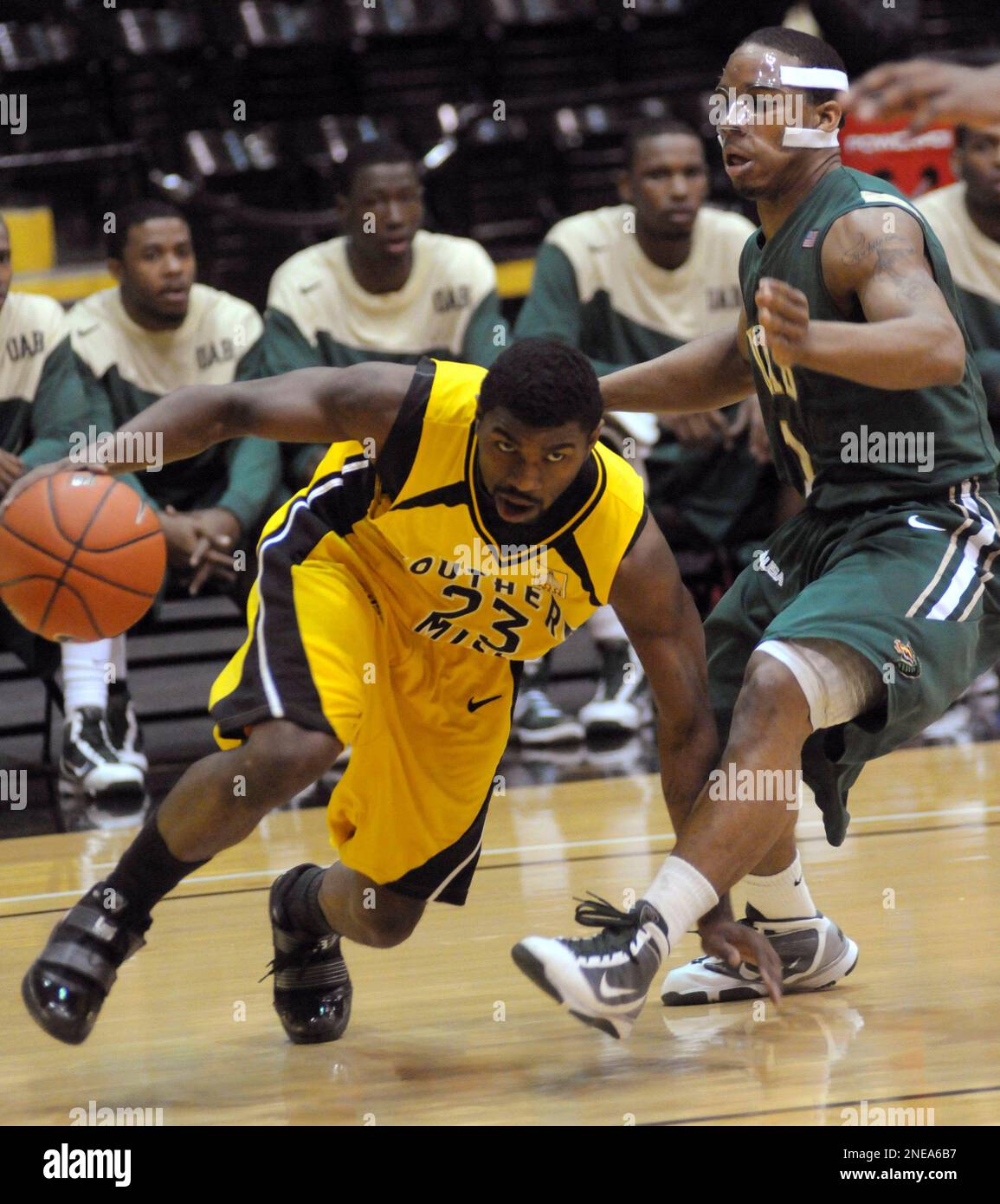 Southern Mississippi guard Angelo Johnson (23) swings around UAB guard ...