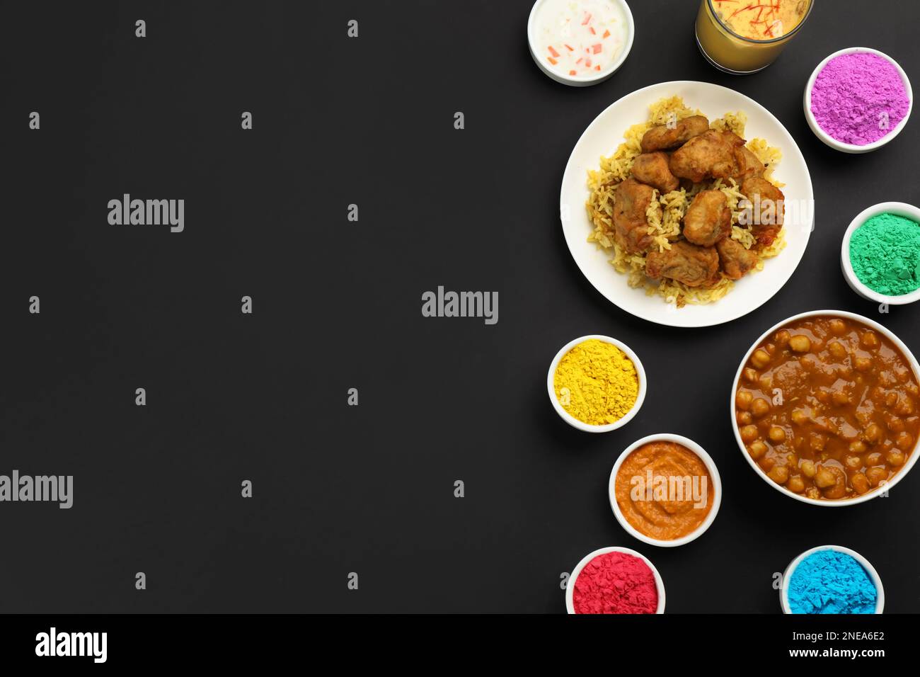 Traditional Indian food and color powders on black background, flat lay ...
