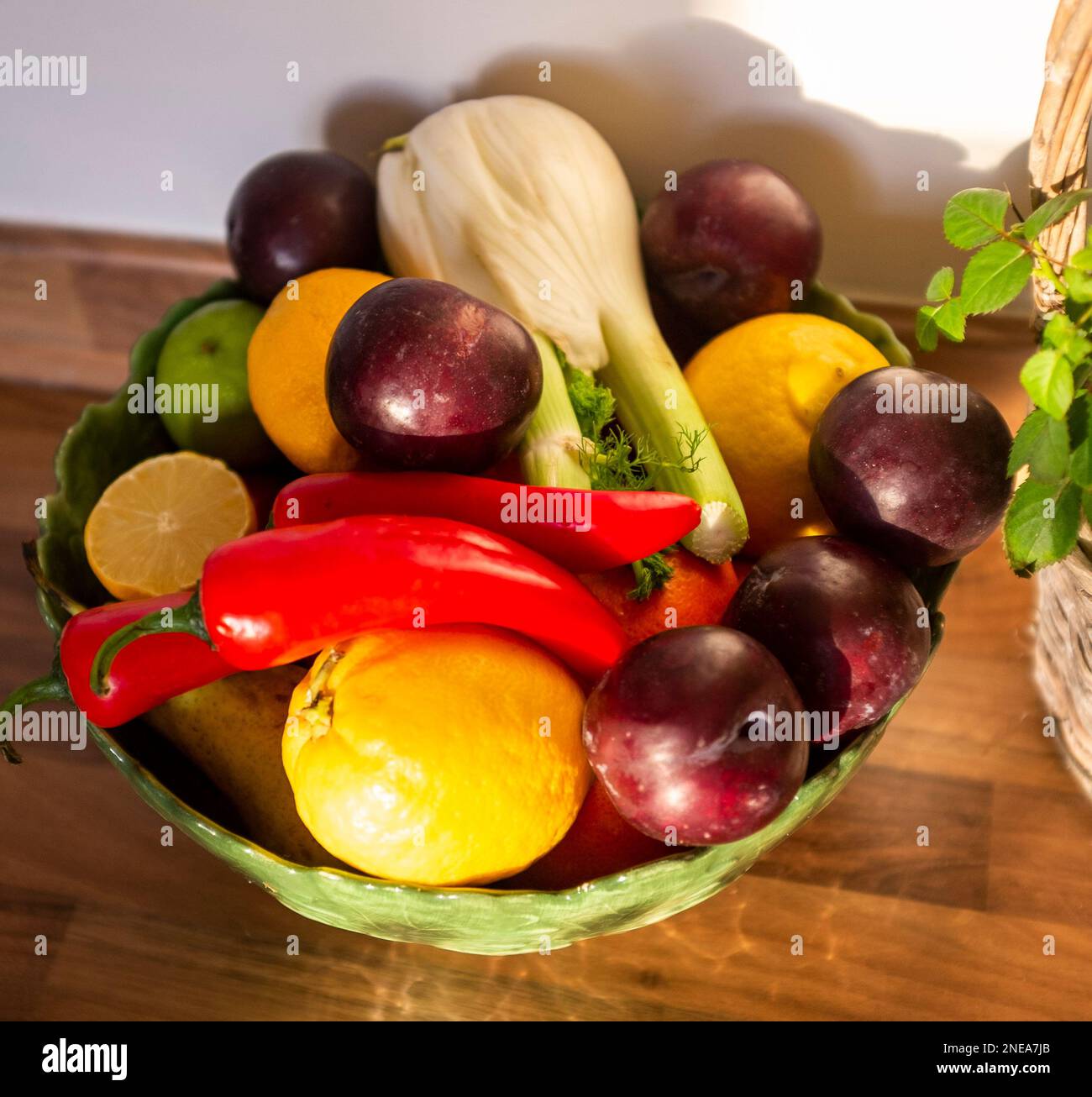 Fruit bowl containing fennel , plums , red chillies and lemons Stock ...