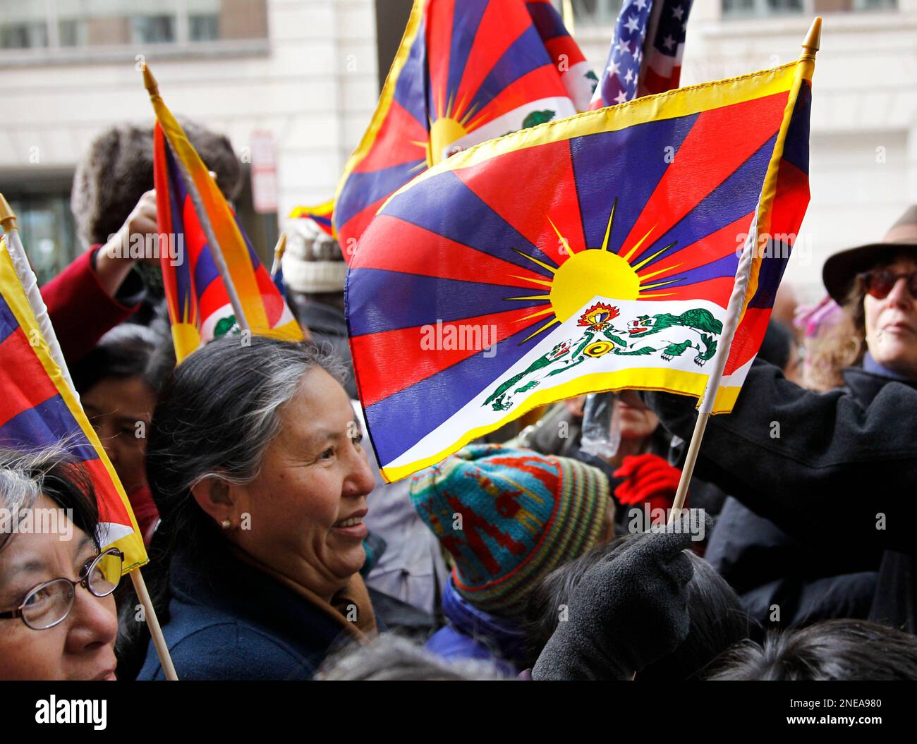 Flags are passed out to the crowd before His Holiness the Dalai Lama ...