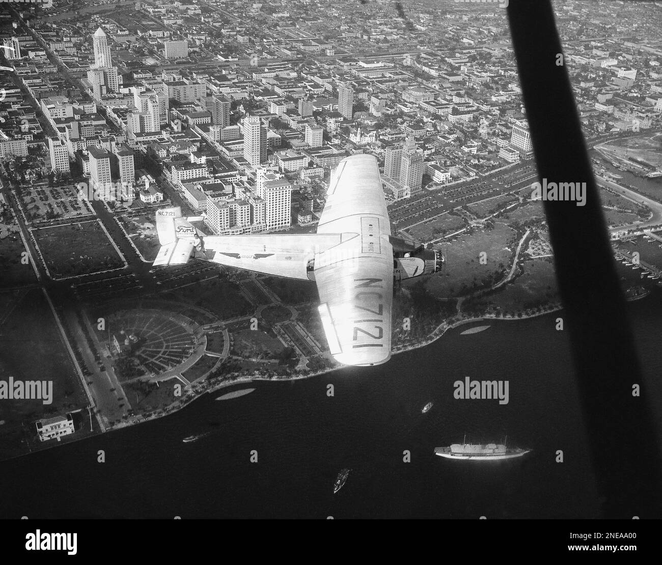 Jimmy Terry, stunt flier, repairs a control cable of a three-motored ...